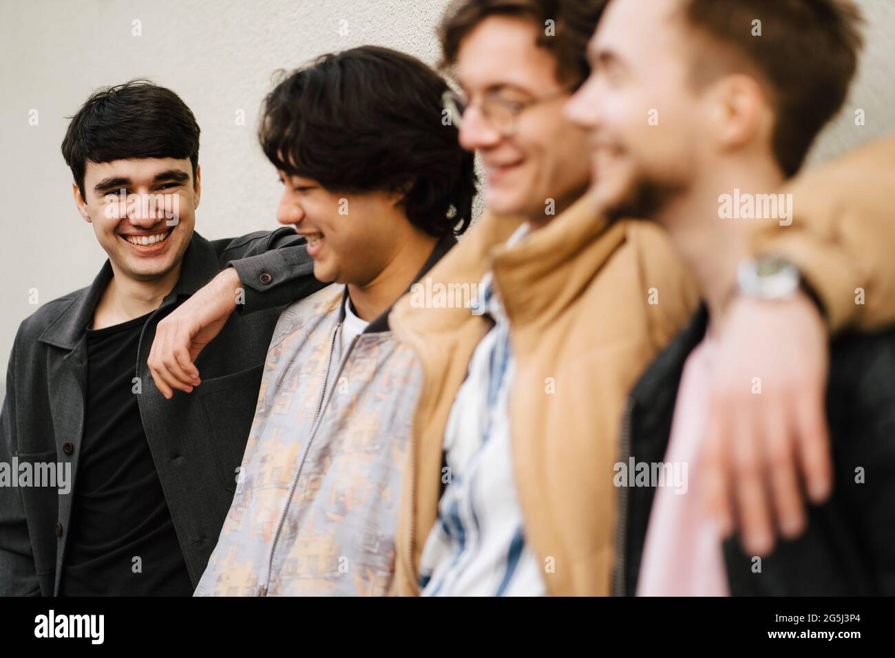 Smiling male friends standing hi-res stock photography and images - Alamy
