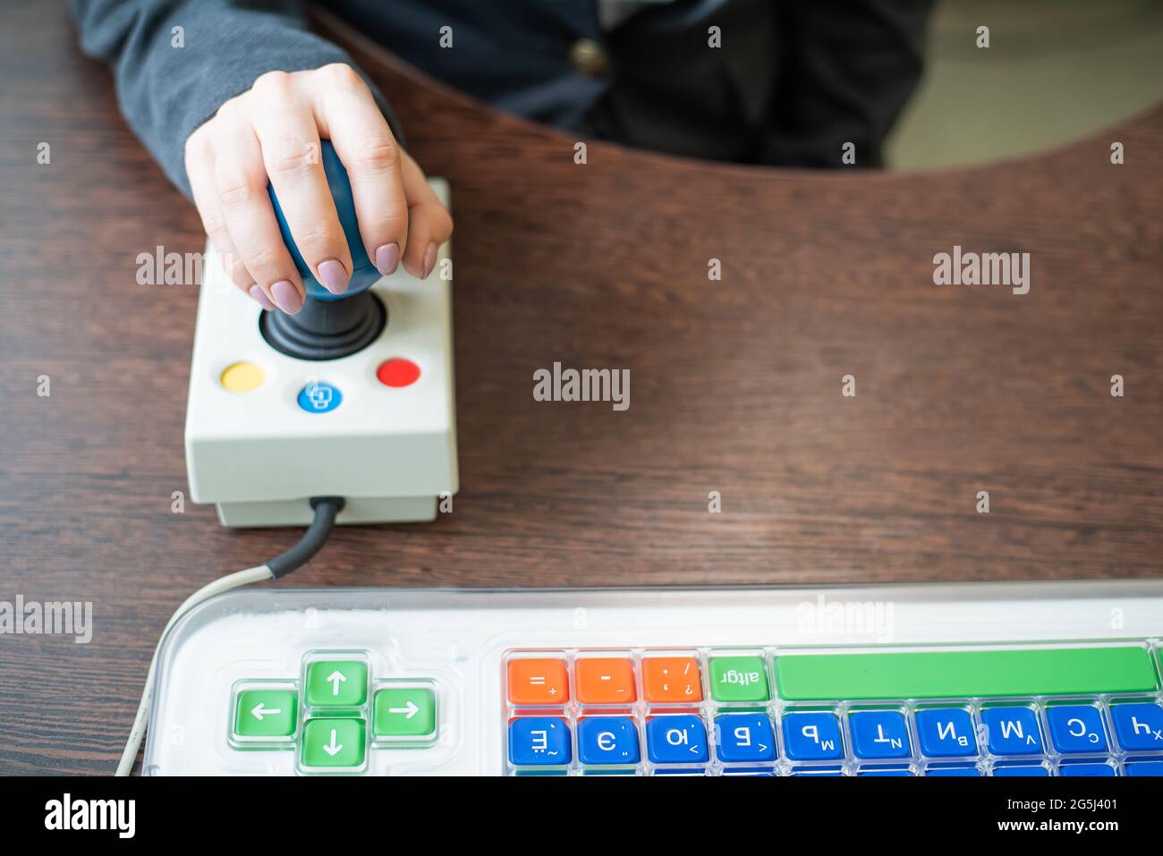 Woman with cerebral palsy works on a specialized computer mouse Stock ...