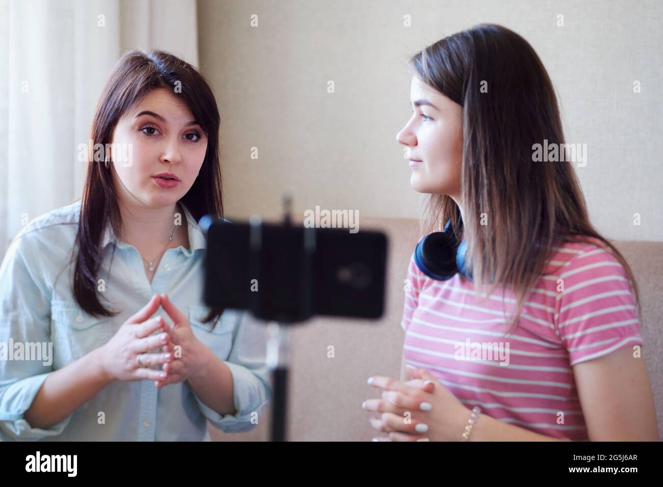 Two girls bloggers are recording interviews with useful tips for users ...