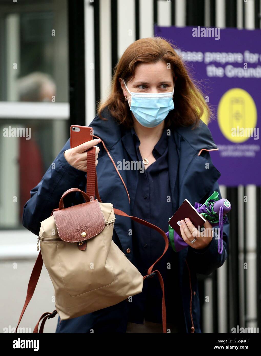 A spectator arrives at gate 12 ahead of day one of Wimbledon at The All ...