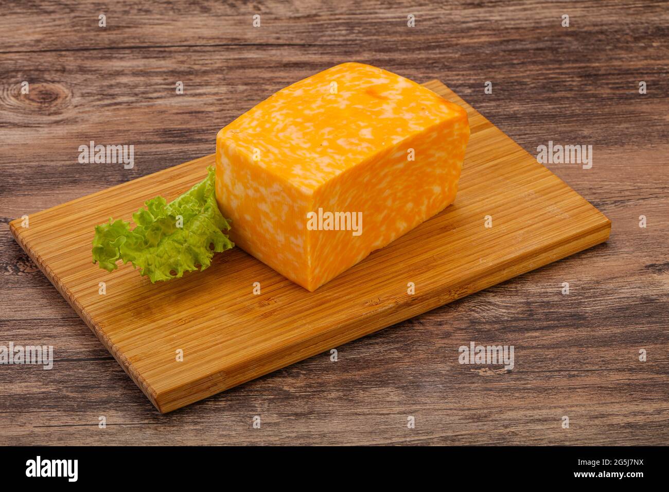 Dairy Marble cheese brick over board Stock Photo - Alamy