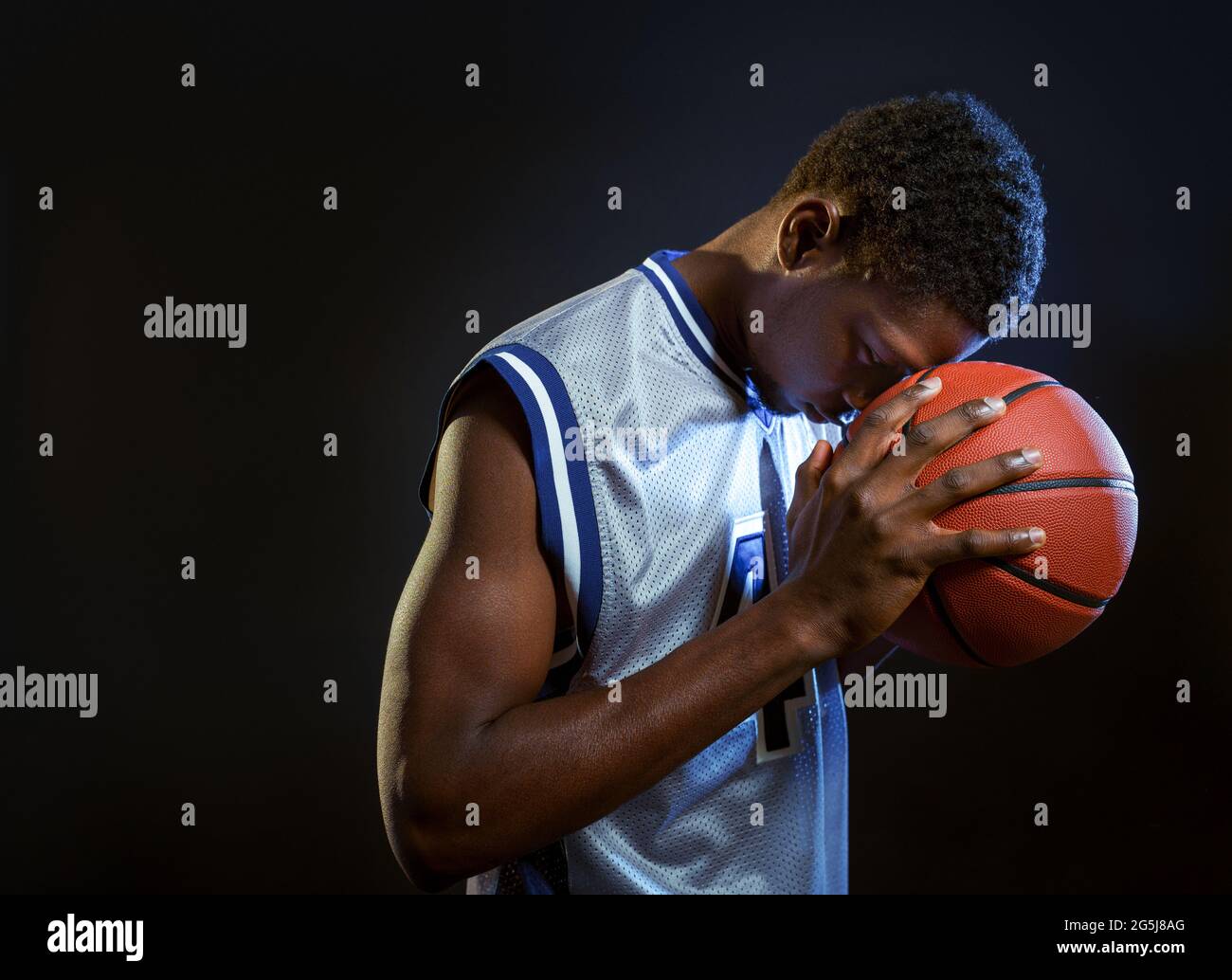 Focused basketball player with ball in studio Stock Photo - Alamy