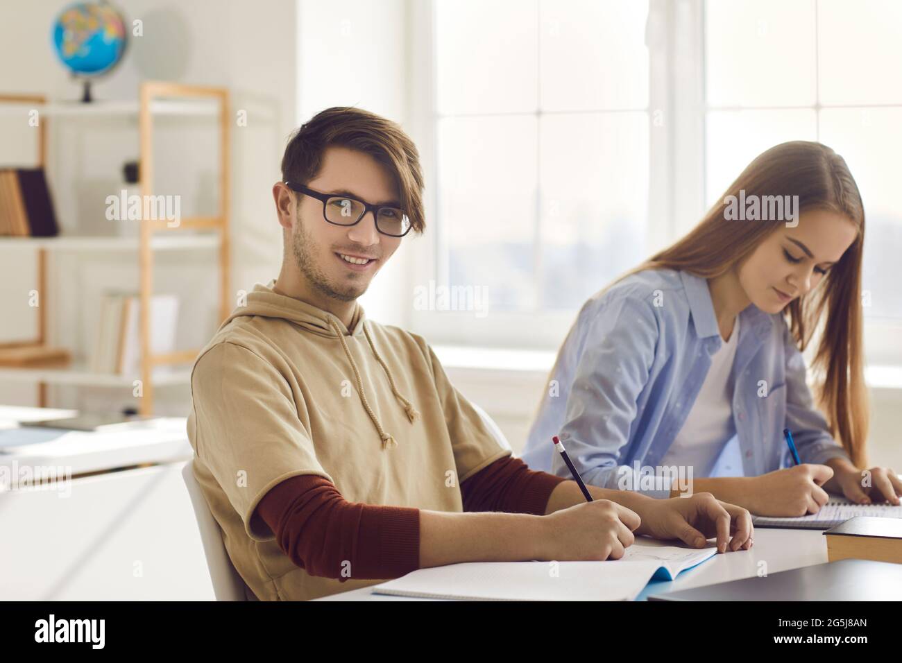 Student writing paper desk hi-res stock photography and images - Alamy