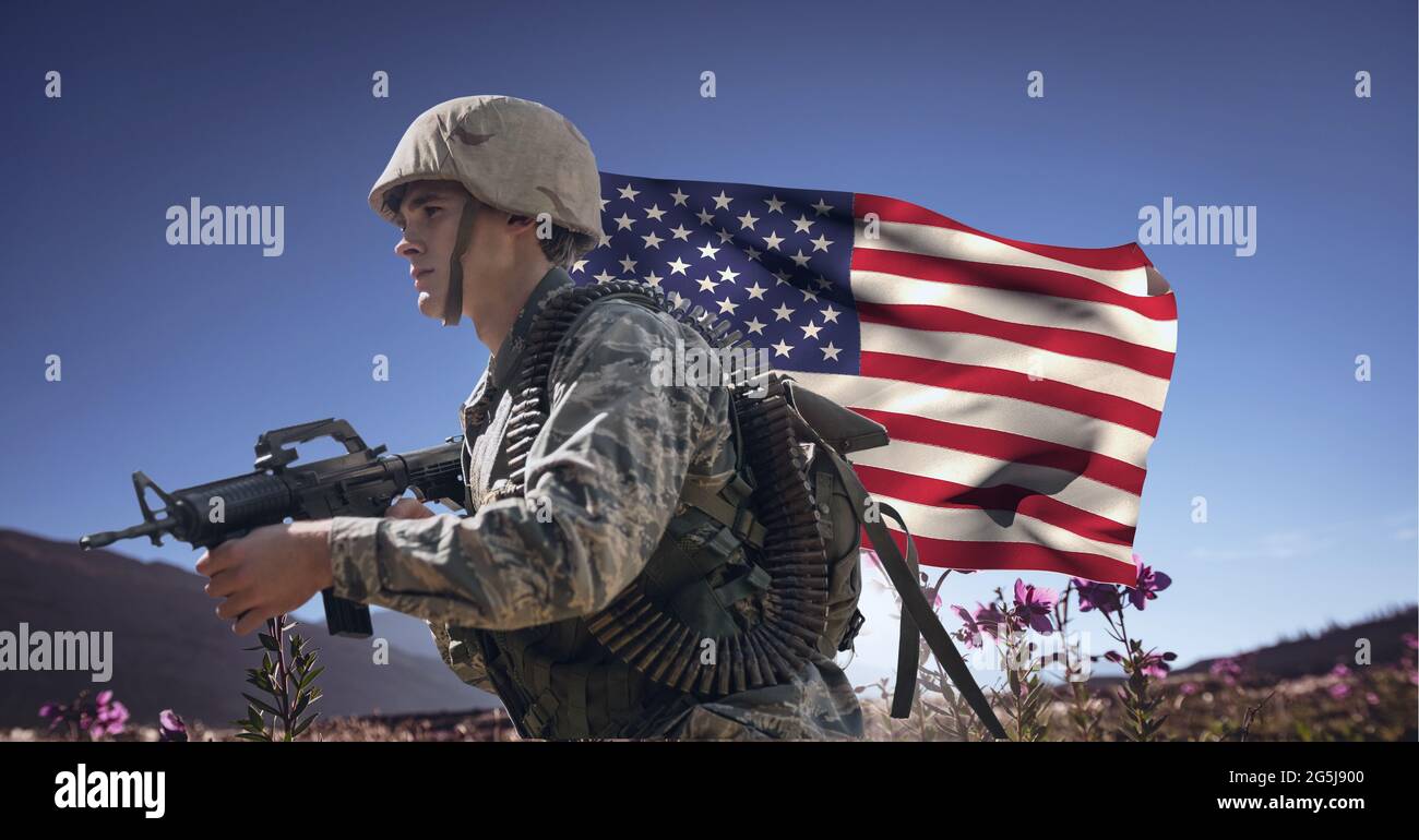 Composition of male soldier holding gun, with waving american flag ...