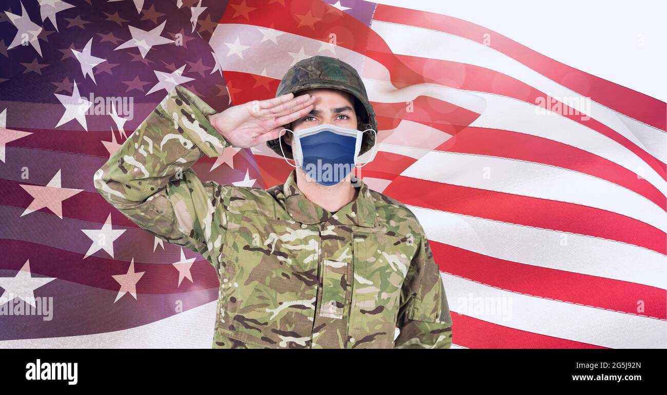 Composition of saluting male soldier wearing face mask, against waving ...