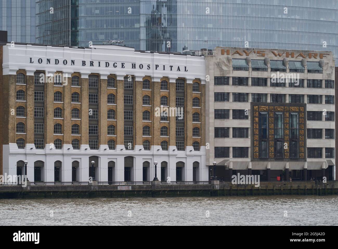 Historic buildings line the River Thames near London Bridge in the City ...