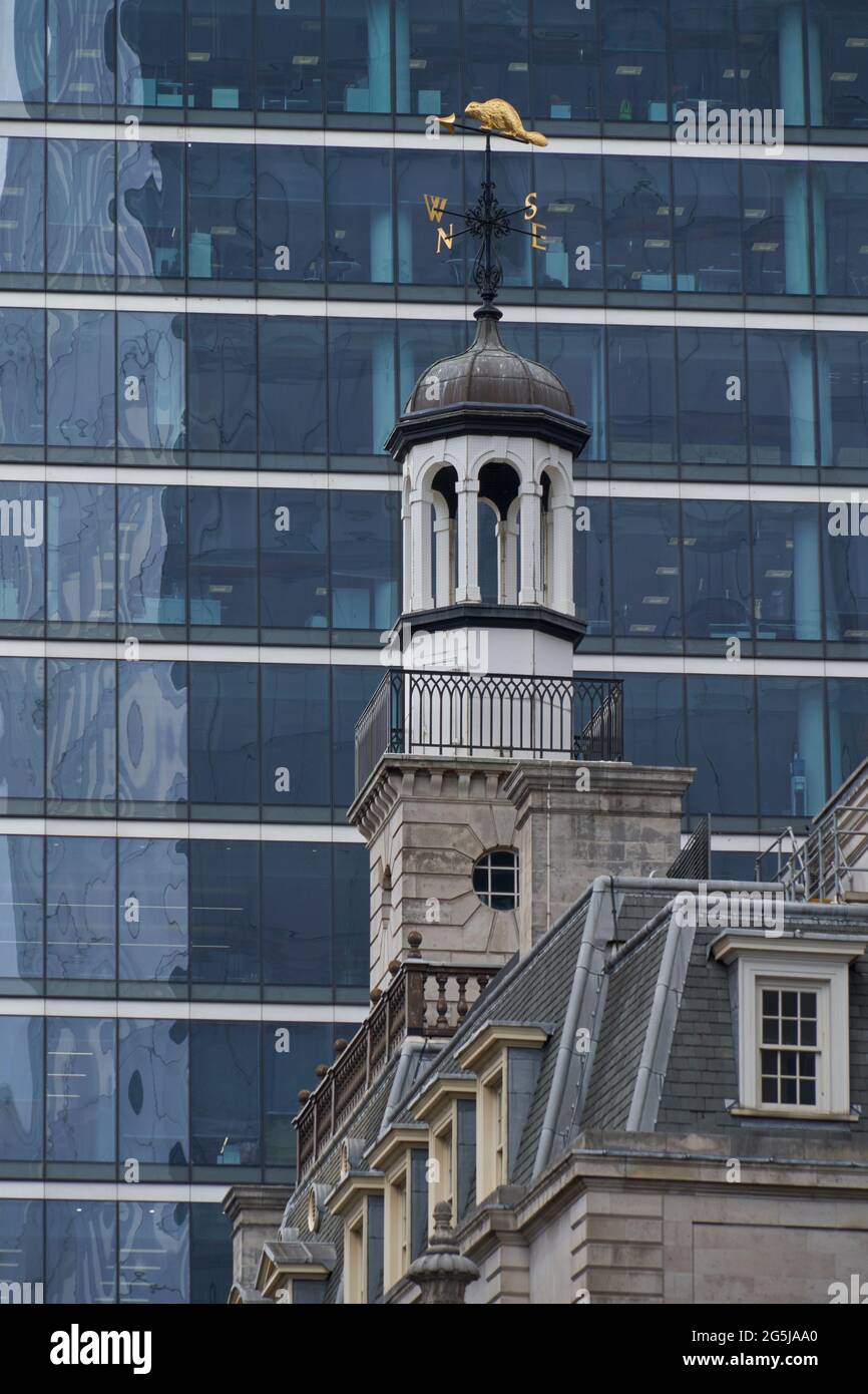 Beaver weathervane on top of a historic building surrounded by modern ...