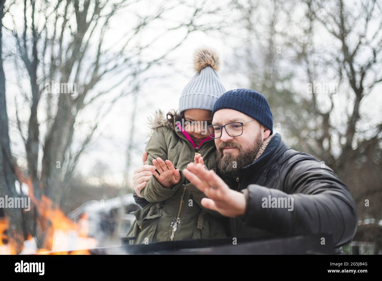 Warming fire hands hi-res stock photography and images - Alamy