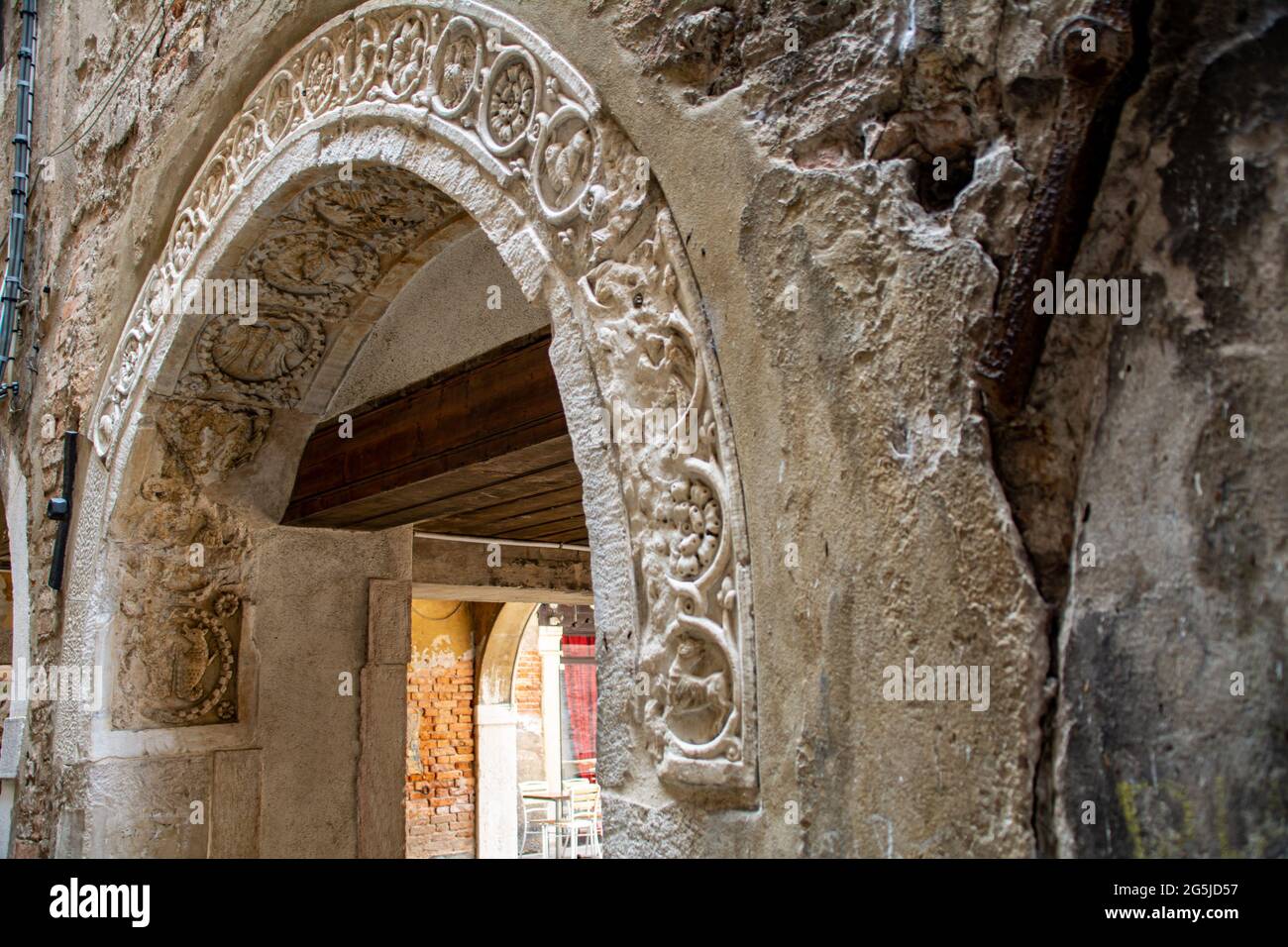 Facade of an historic building in Venice, Italy with a frieze of a ...