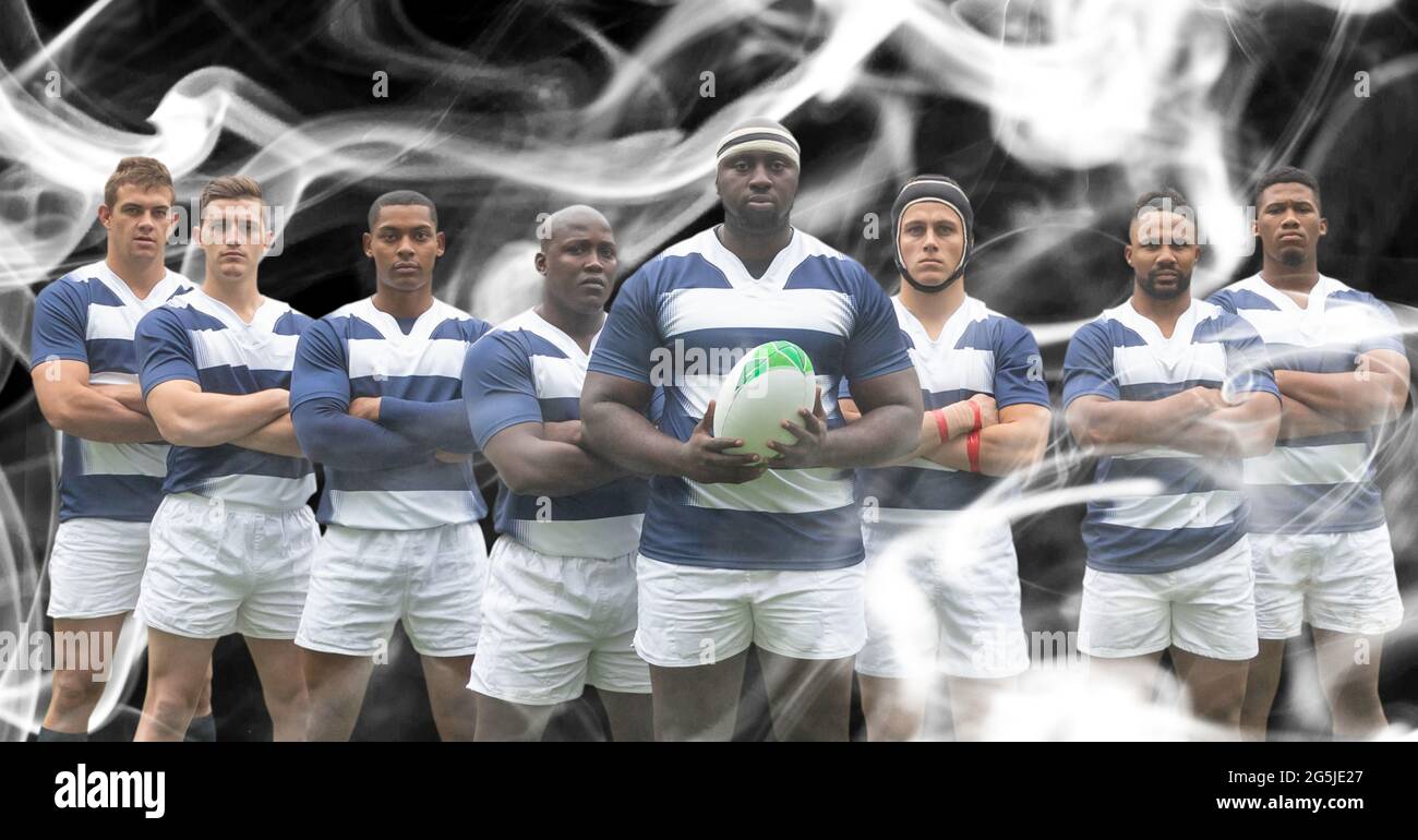 Composition of male rugby team holding rugby ball on black background ...