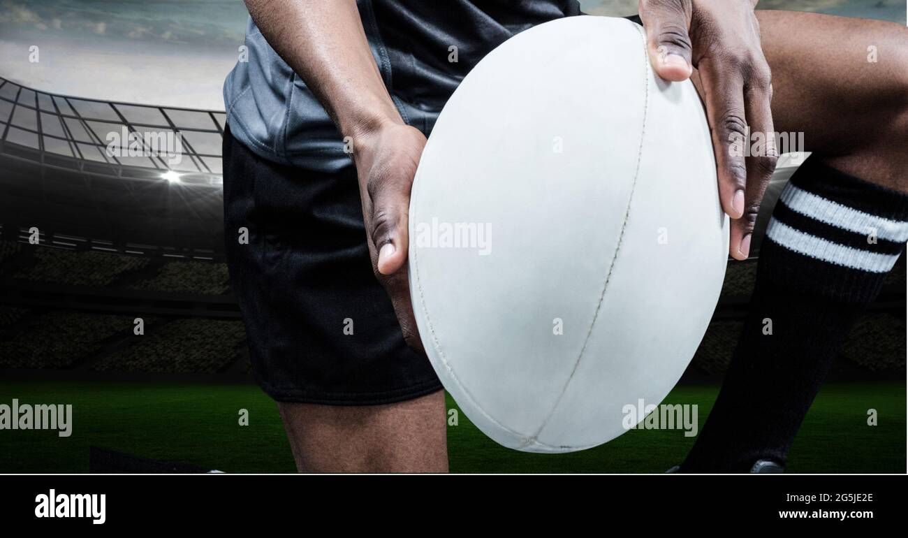 Composition of male rugby player holding rugby ball at stadium Stock ...