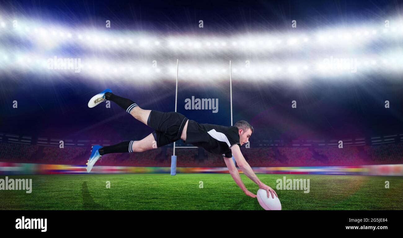 Composition of male rugby player catching ball at stadium Stock Photo ...