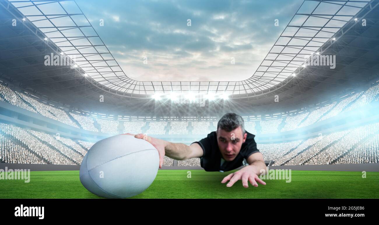 Composition of male rugby player catching ball at stadium Stock Photo ...