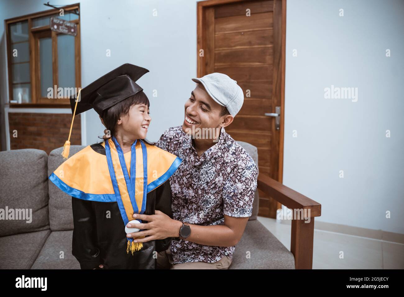 Kindergarten graduation. asian father embrace his daughter Stock Photo ...