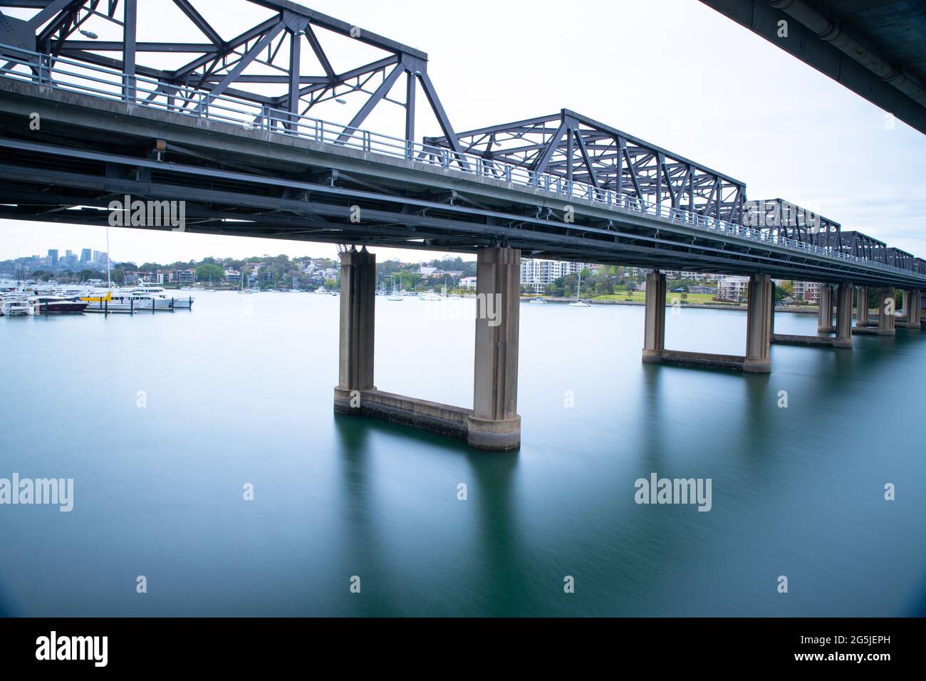 Old iron bridge and new concrete bridge side by side on Sydney harbour ...