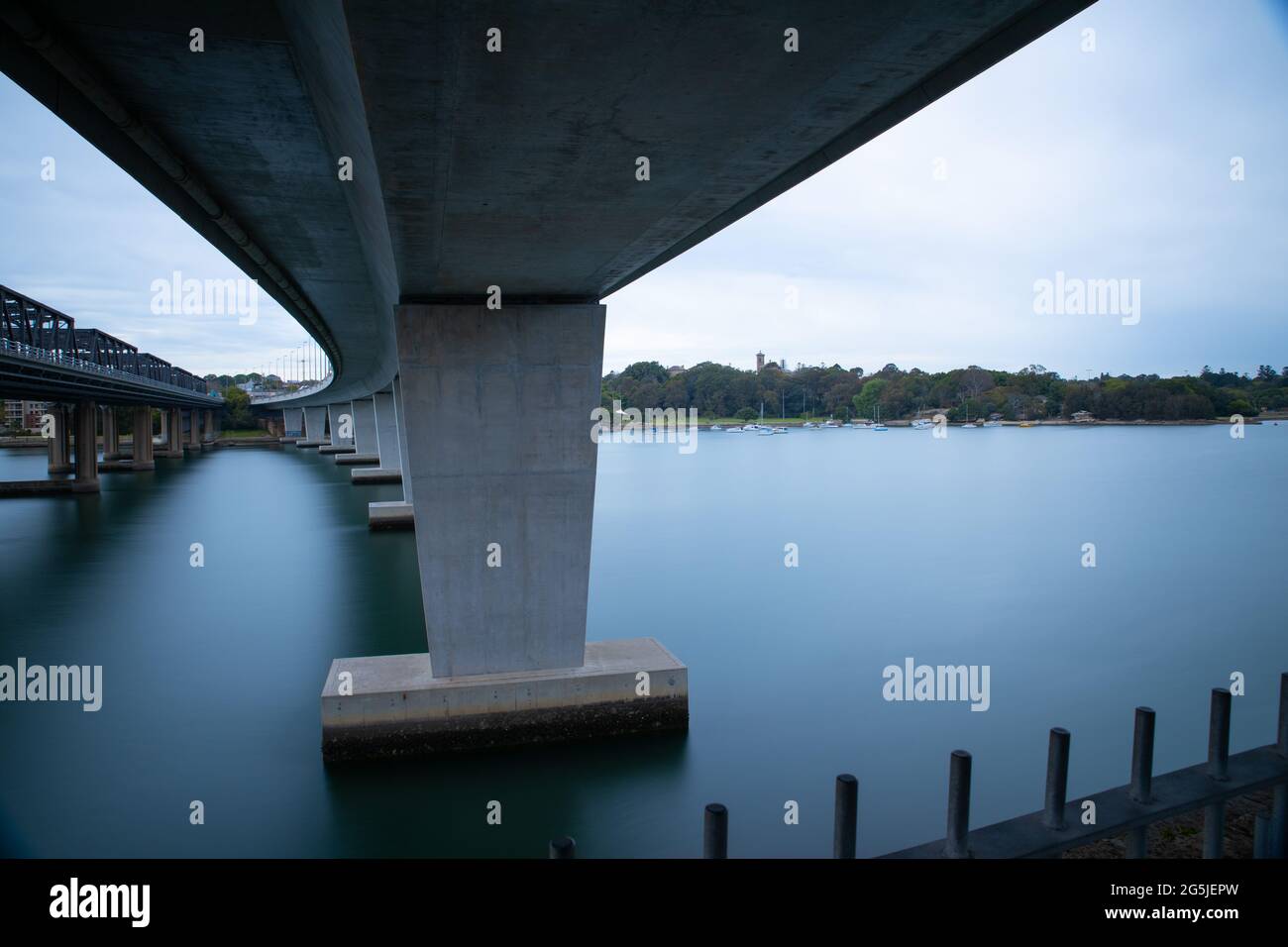 Old iron bridge and new concrete bridge side by side on Sydney harbour ...
