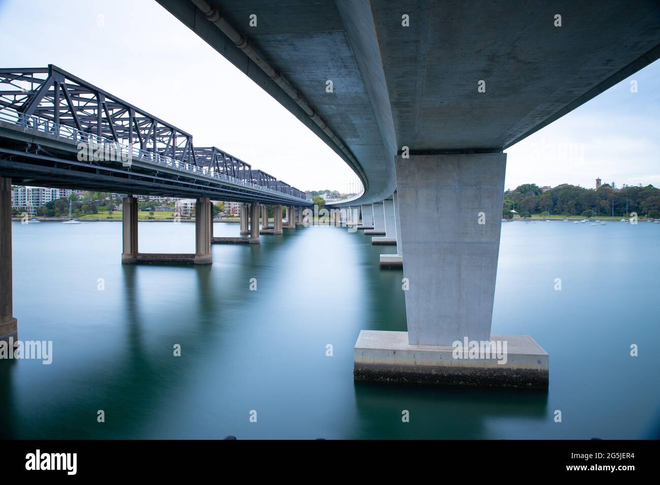 Old iron bridge and new concrete bridge side by side on Sydney harbour ...