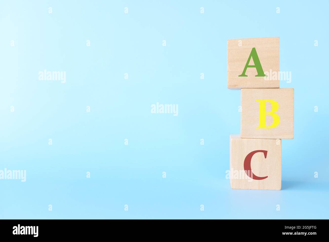 Colorful ABC letters on wooden blocks in blue background with copy ...