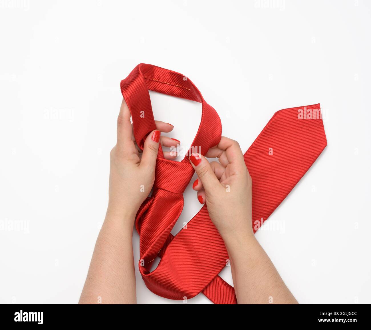two female hands hold a red silk tie on a white background Stock Photo ...