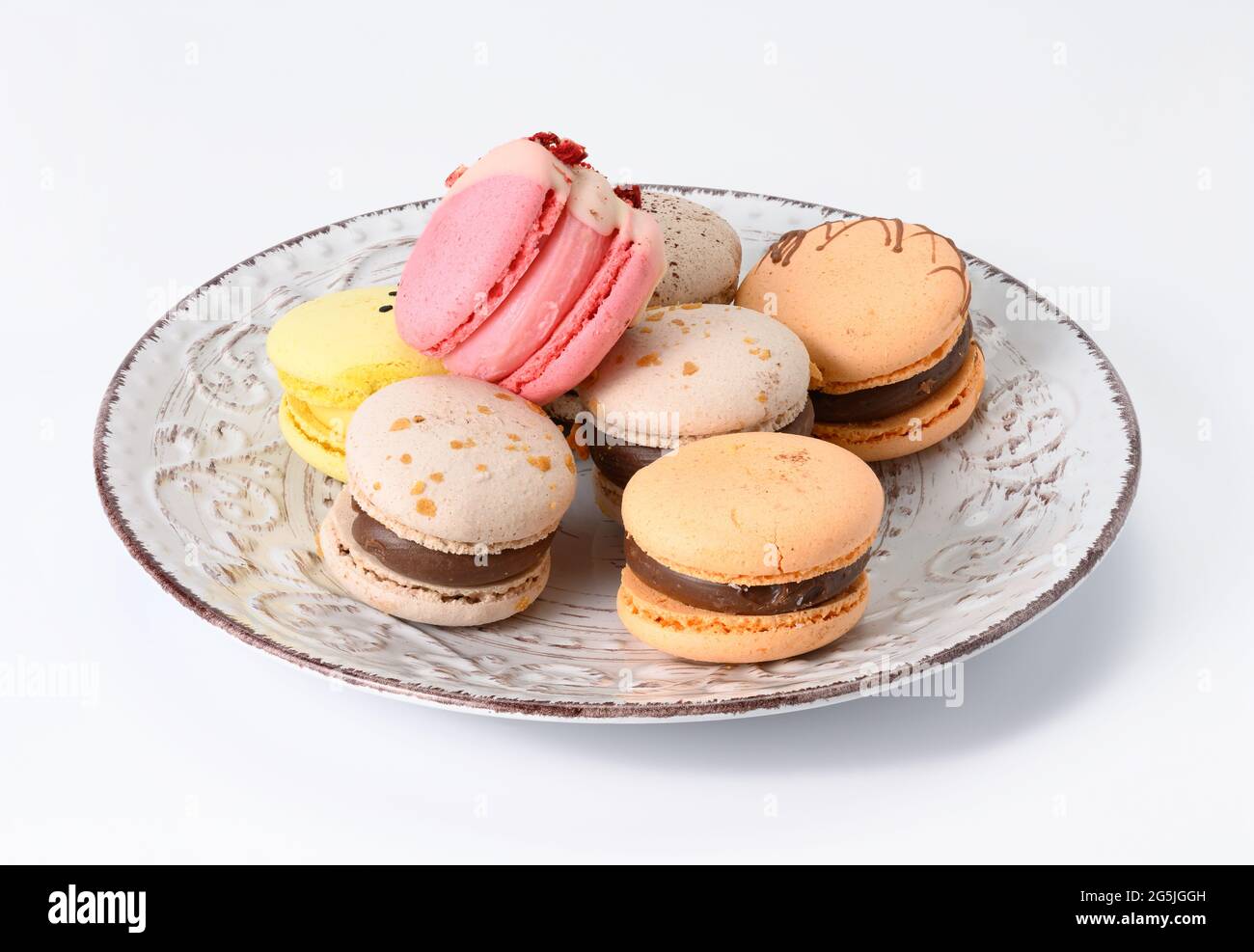 baked almond macarons on a white ceramic plate, white background Stock ...
