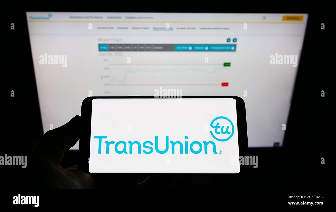 Person holding mobile phone with logo of US credit reporting agency ...