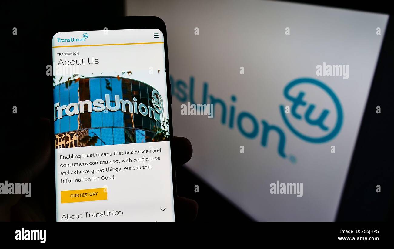 Person holding cellphone with webpage of American credit reporting ...