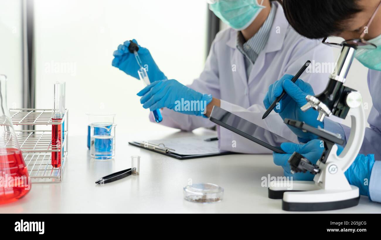Team of Medical Research Scientists or researcher in lab coat testing ...