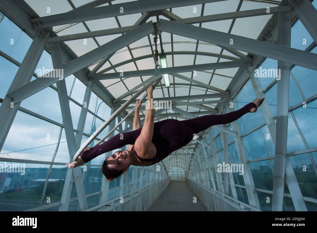 An air gymnast makes a Russian splits on an air hoop suspended on a ...