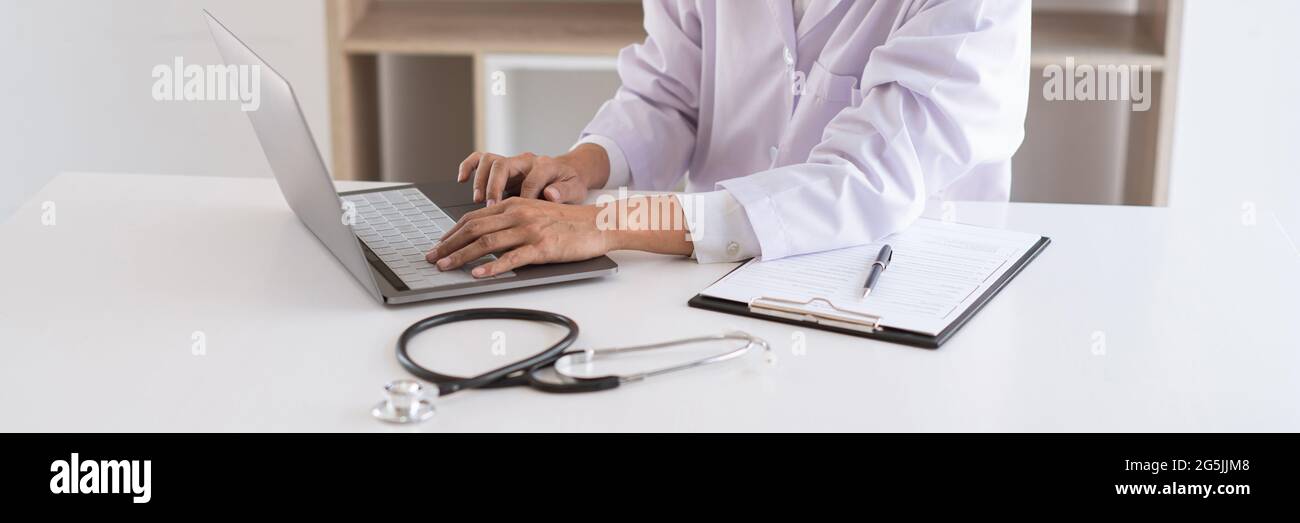 A female doctor reading and interpreting laboratory results performing ...