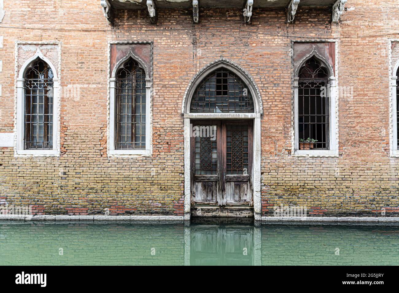 Typical Venetian door to the canal. Traditional entrance to a building ...