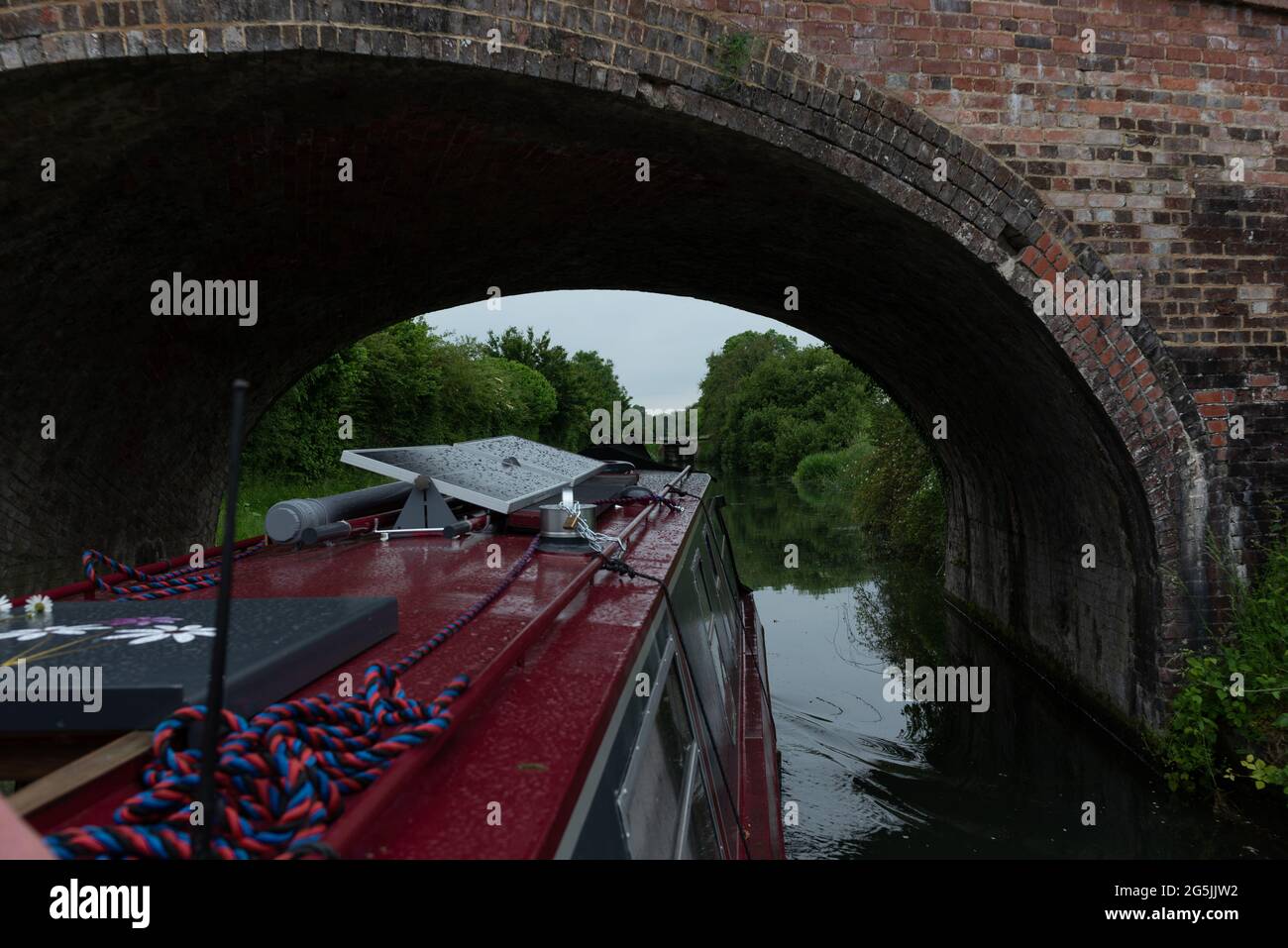 Barge going under road bridge Kennet and avon canal Stock Photo - Alamy