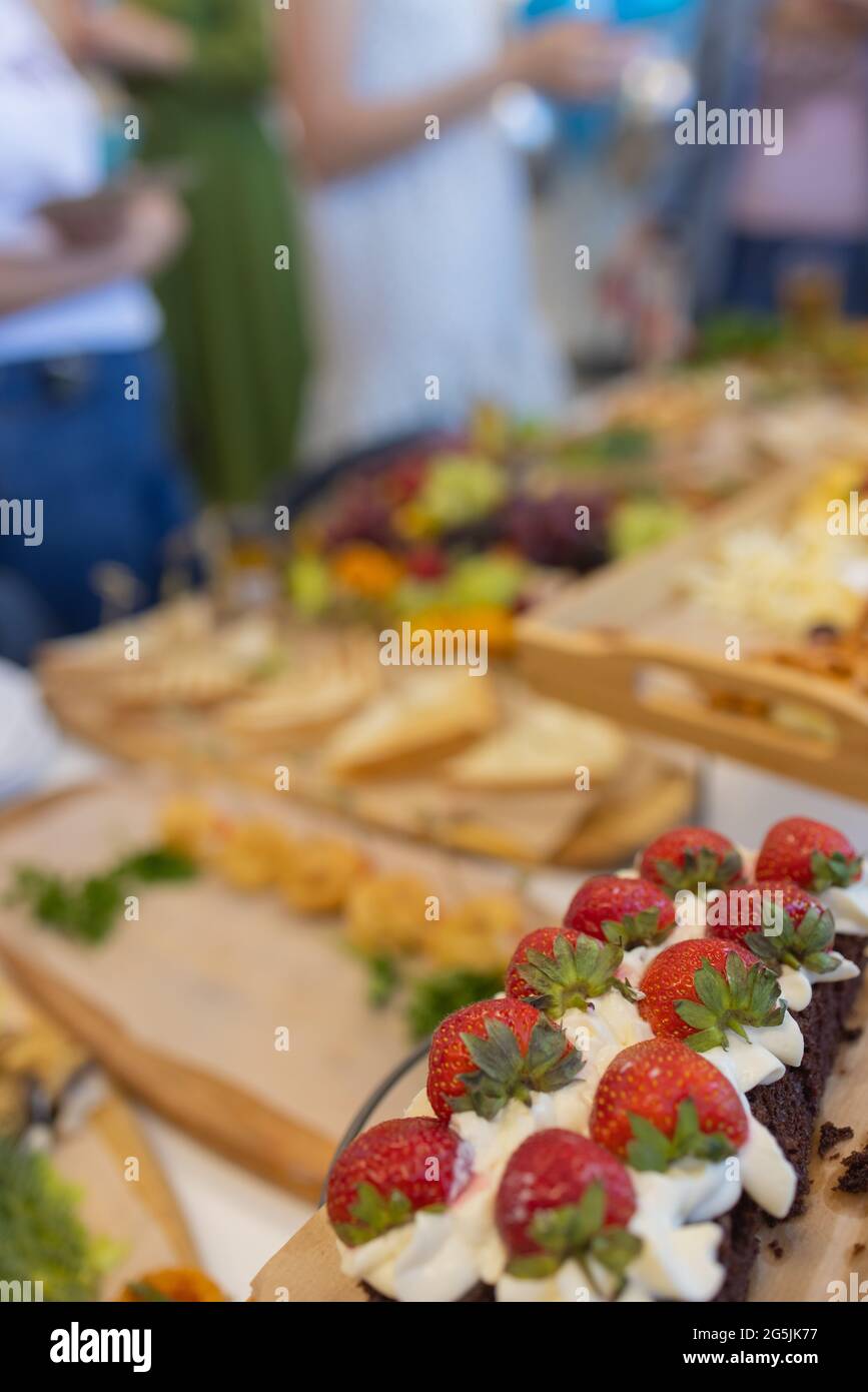 Dinner table with snacks decorated with beautiful summer flowers. Food ...