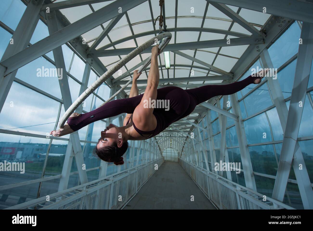 An air gymnast makes a Russian splits on an air hoop suspended on a ...