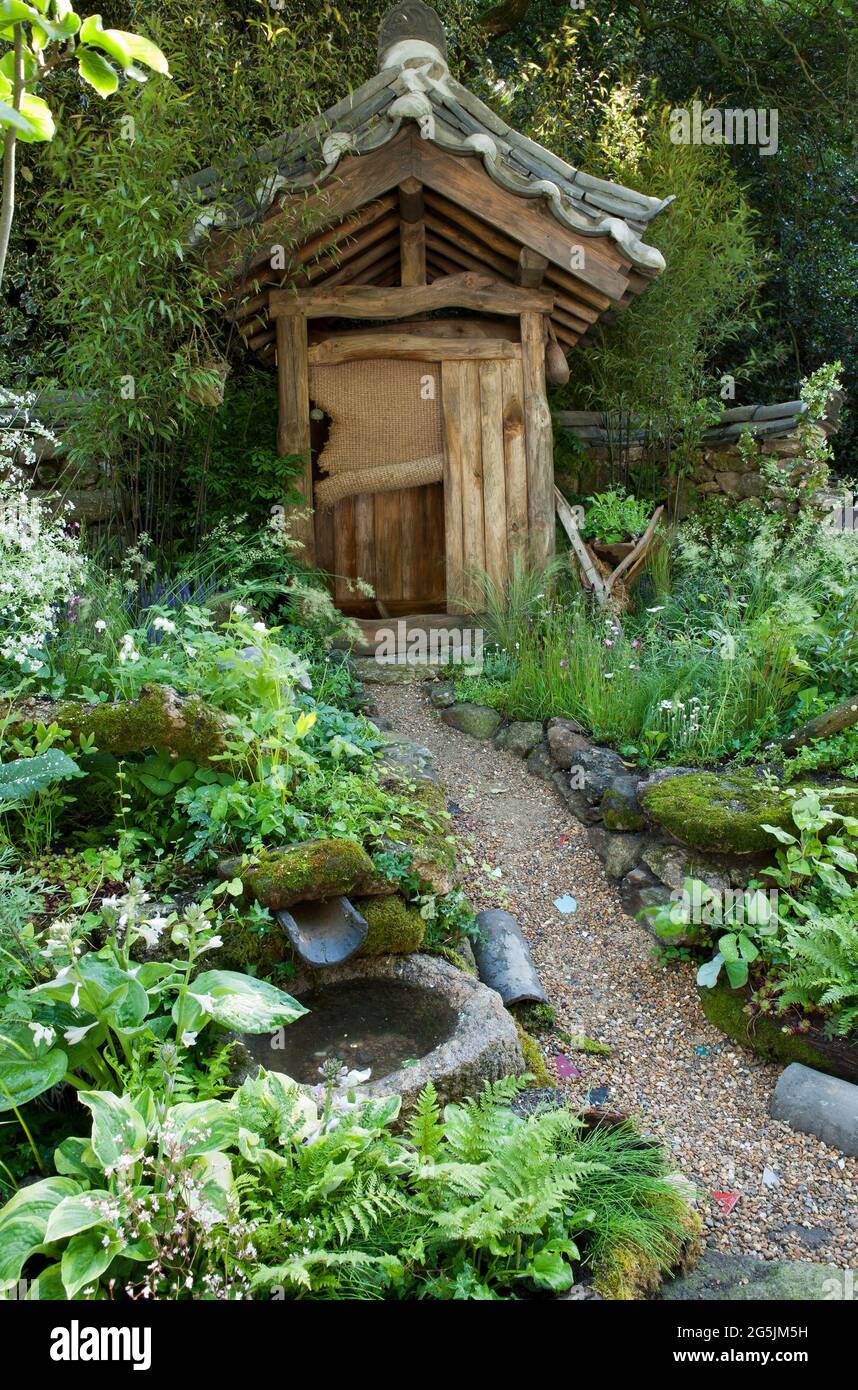 Wooden Oriental pavilion toilet, gravel path, drain pipe stone water ...