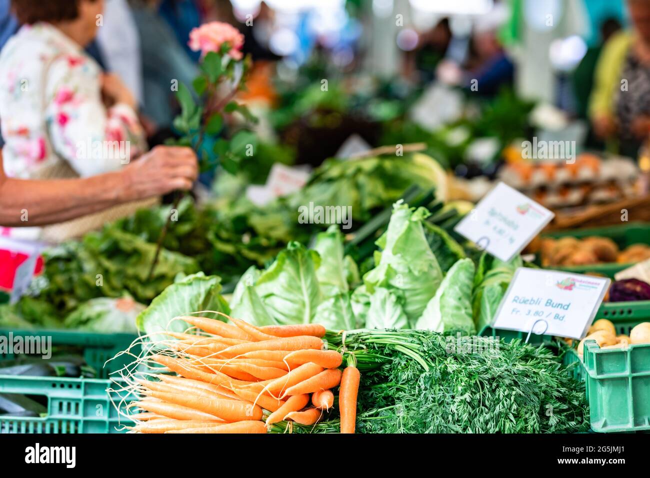 Variety of farmers' fresh vegetables for sale at the market.Blurred ...