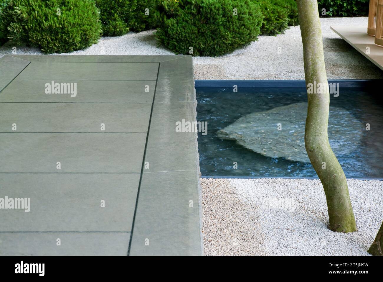 Japanese inspired garden with stone water feature Stock Photo - Alamy