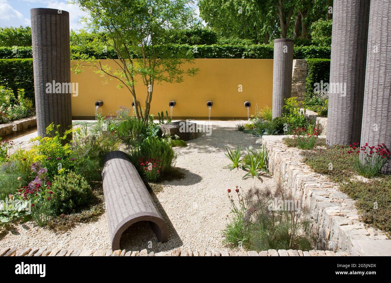 Sunken gravel garden with water pipes and sculpted columns Stock Photo ...