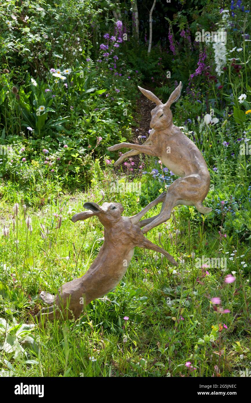 Hare statue in woodland garden Stock Photo - Alamy