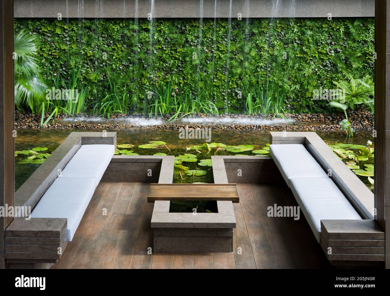 Tropical water garden with seating Stock Photo - Alamy