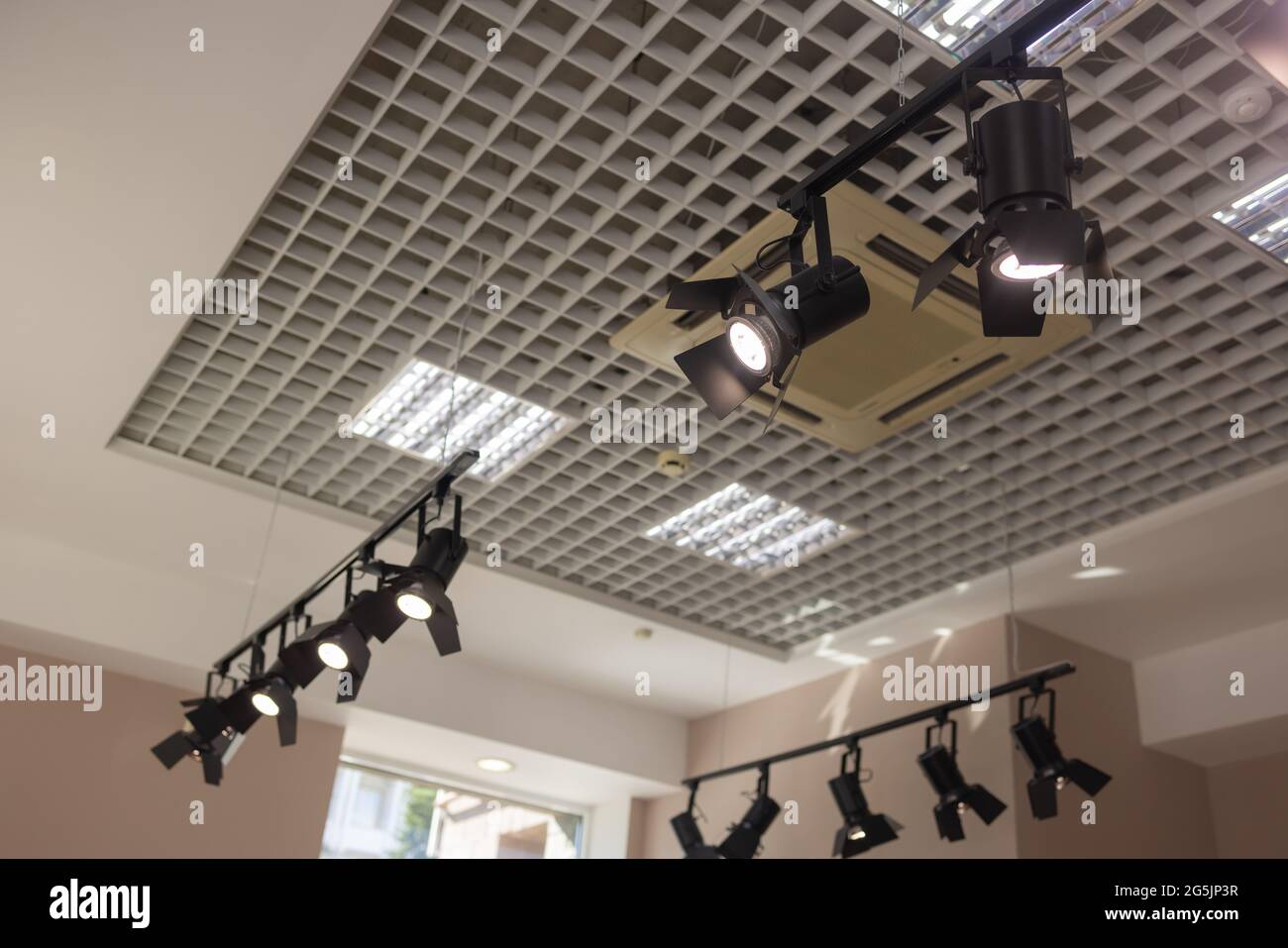 Spotlights under the ceiling on the wall. Track LED-lighting system ...