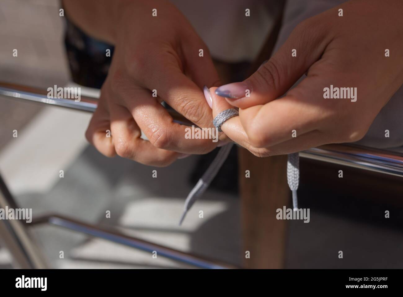 Human hands tie a knot on a rope. The concept of friendship and love ...