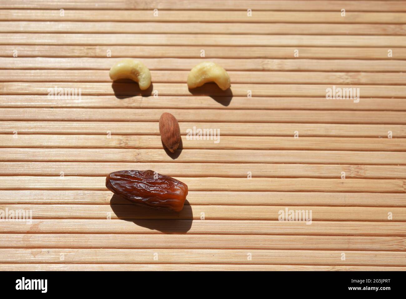 Smiling face made of nuts and dried fruits Stock Photo - Alamy
