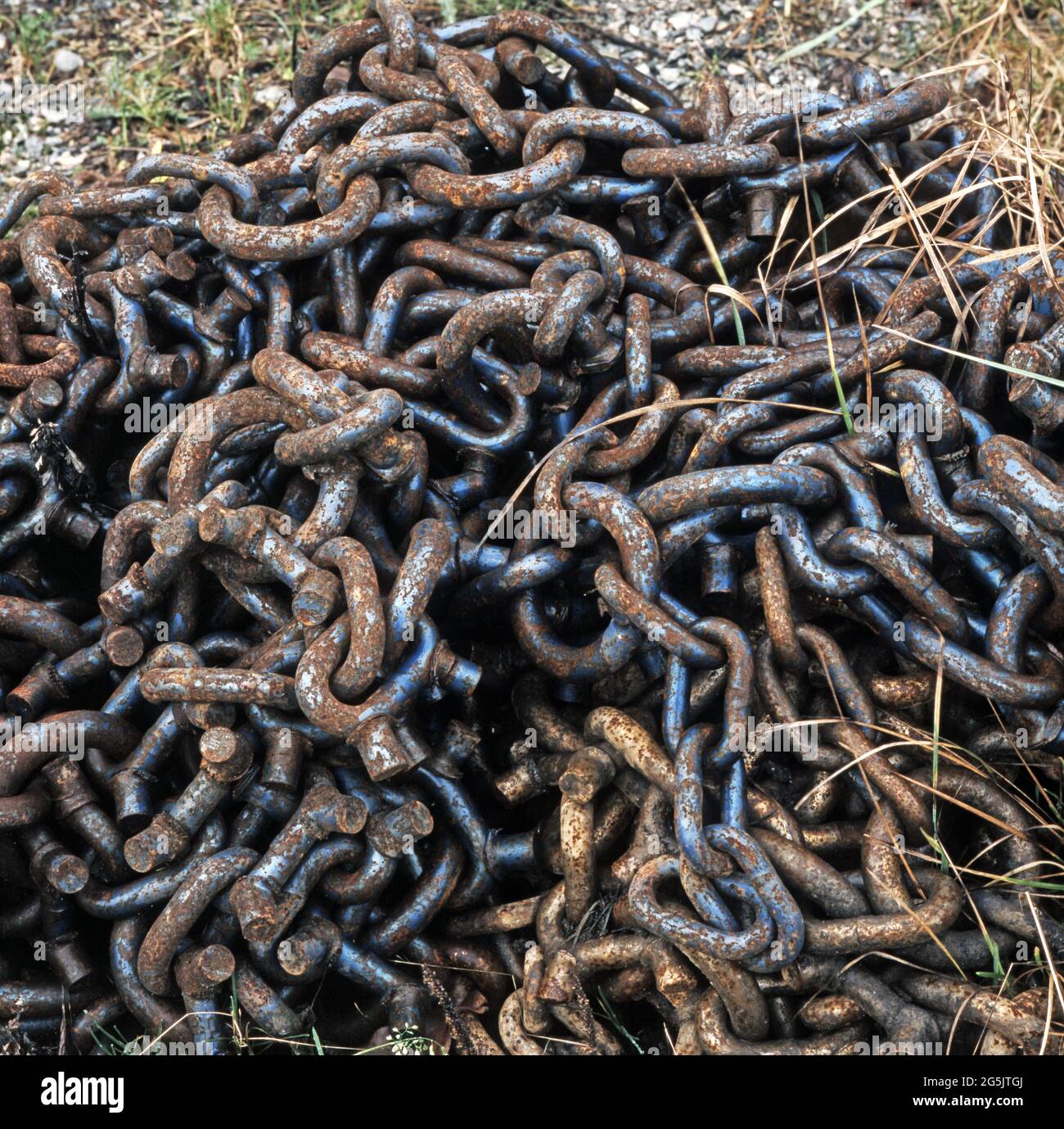 Old rusty industrial heavy duty chains lying at a workplace in sormland ...