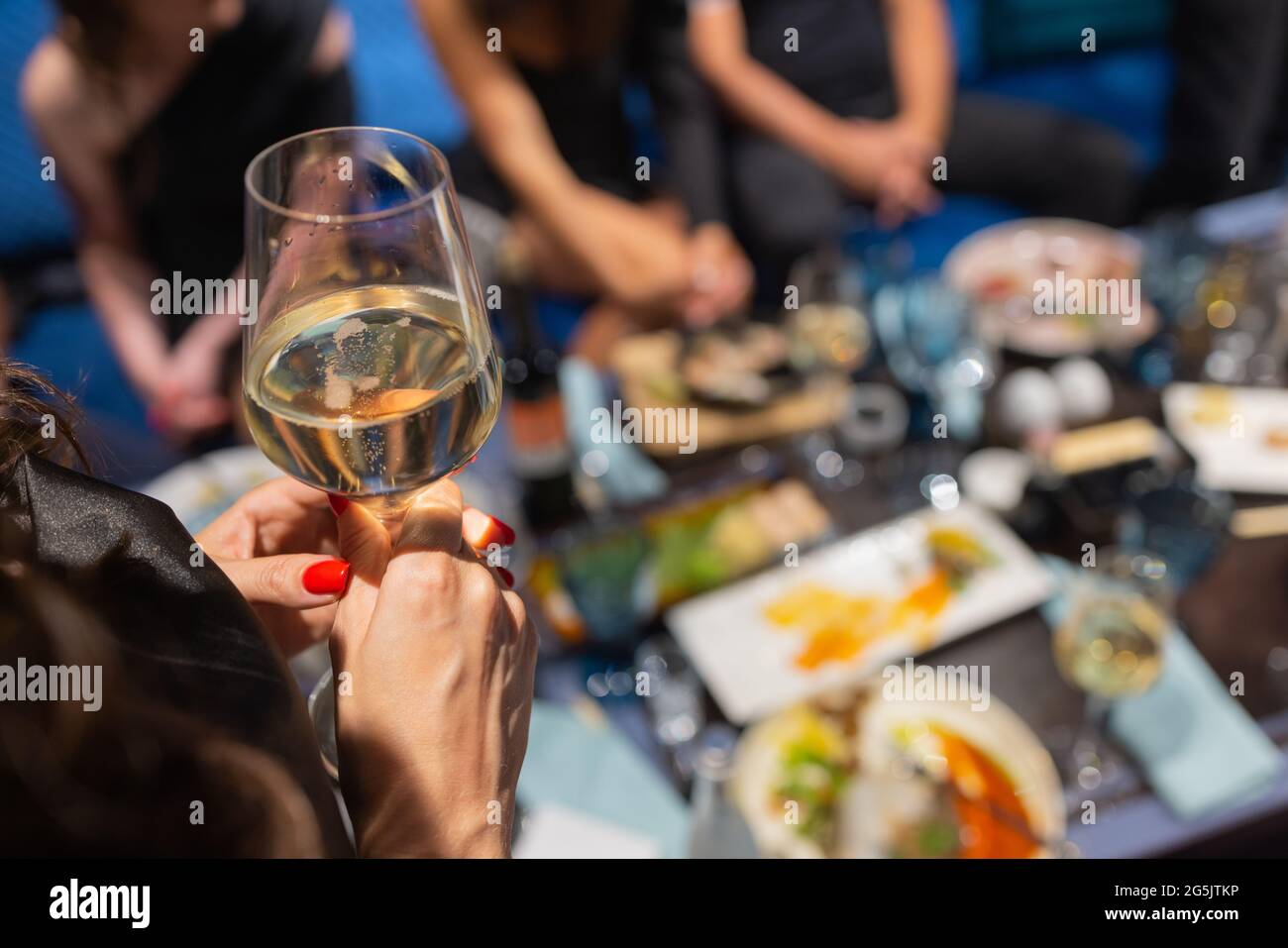 Clinking glasses with alcohol and toasting, party Stock Photo - Alamy