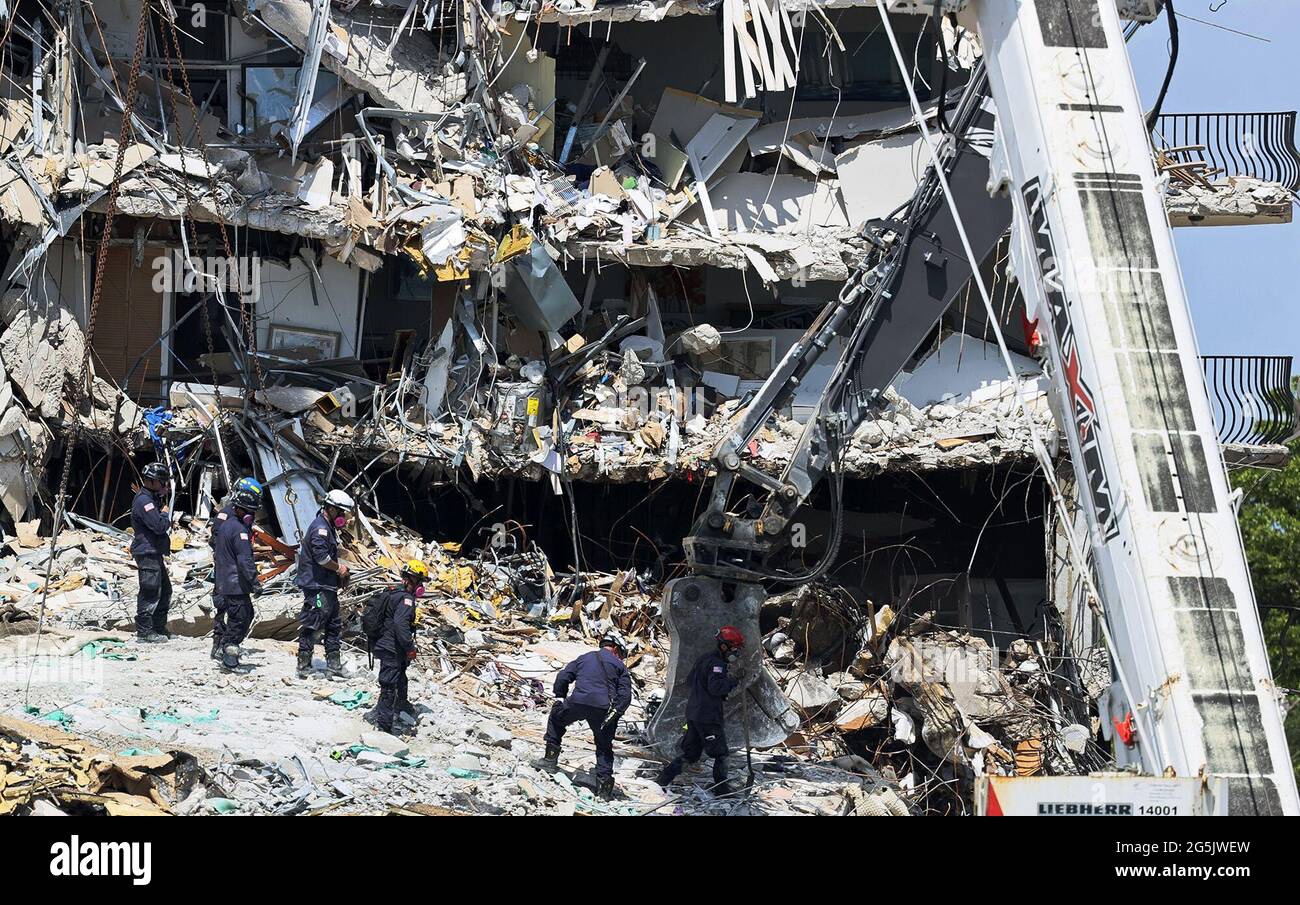 Search and rescue personnel search for survivors through the rubble at ...