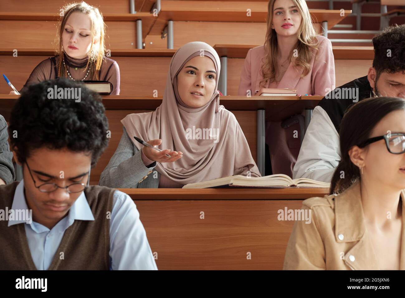 Student in hijab explaining her opinion to teacher at lesson Stock ... Student in hijab explaining her opinion to teacher at lesson Stock ...