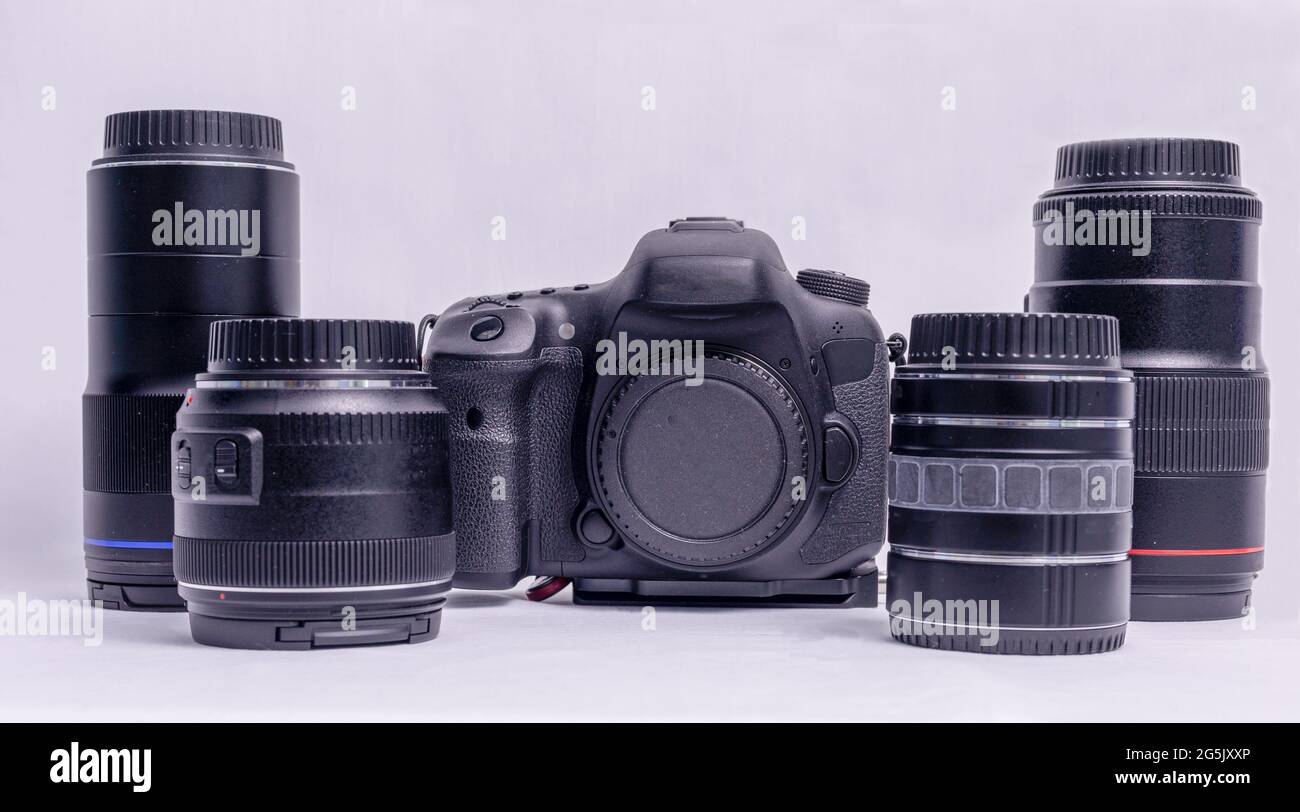 collection of camera equipment including a camera body and four lenses ...