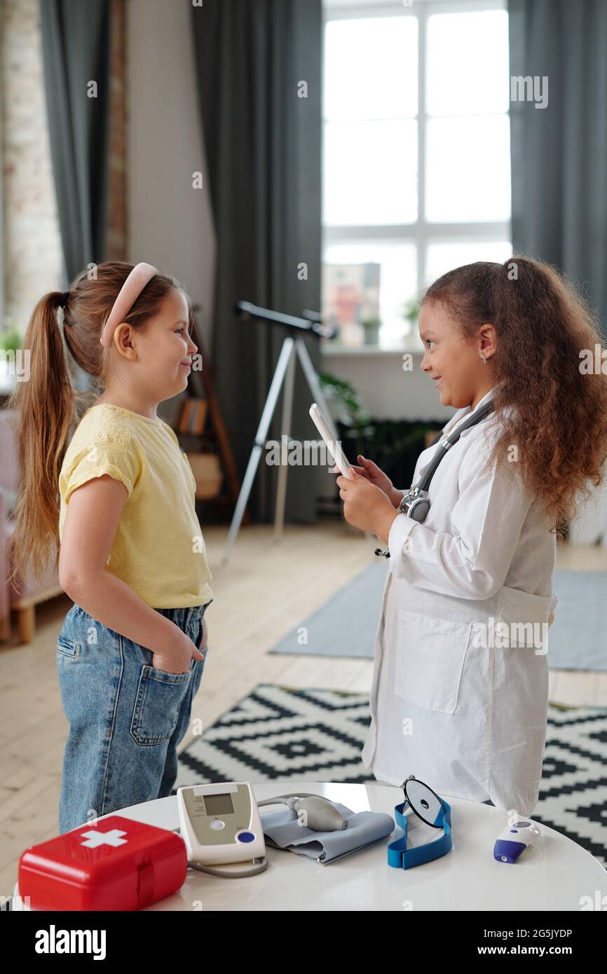 Little Girl In Whitecoat Consulting Her Patient At Home Stock Photo Alamy