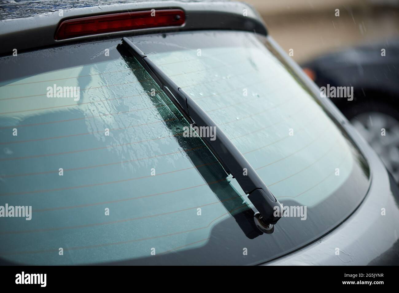 Working windshield wiper of a car in the rain Stock Photo - Alamy