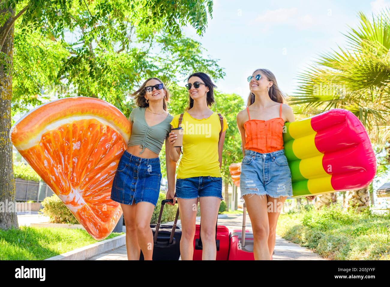 Group of friends walking on the street on the weekend hi-res stock ...